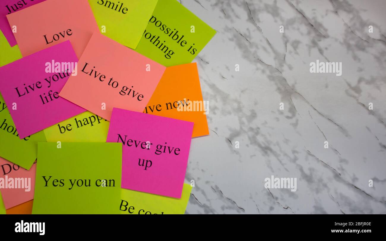 Motivational words on colorful stickers on a marble table. Business ...