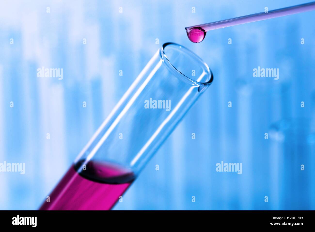 Test tubes on blue background Stock Photo - Alamy