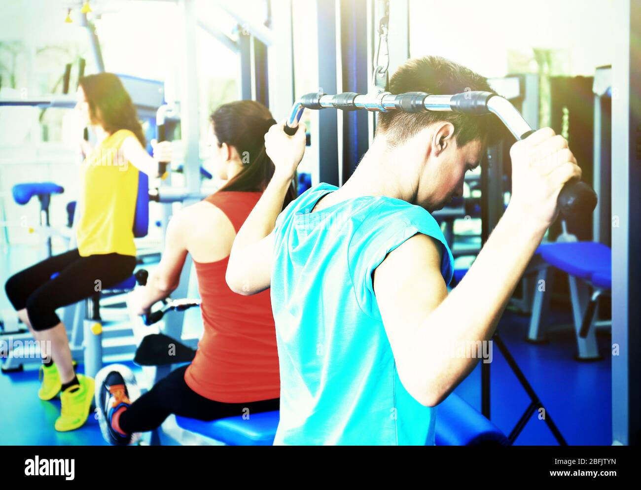 Group of people training with weights in gym Stock Photo - Alamy