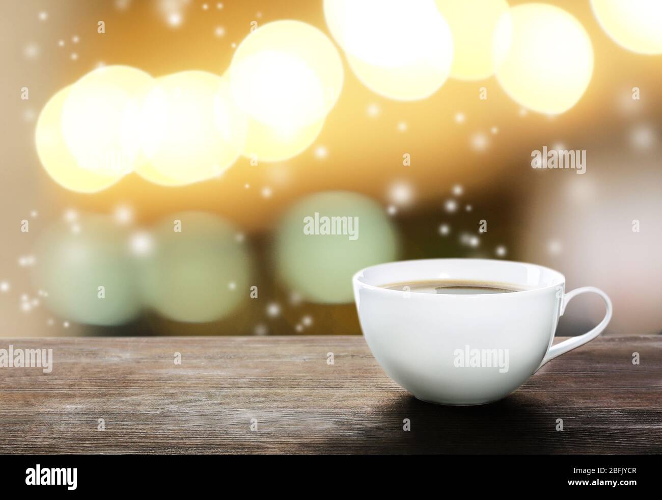 Cup of hot drink on bright background Stock Photo - Alamy