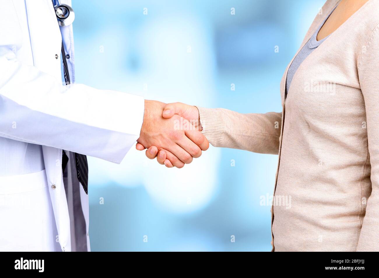 Doctor and patient, on hospital background Stock Photo - Alamy