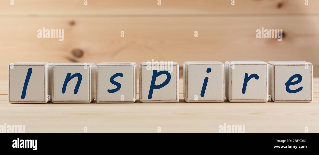 INSPIRE spelled in wooden blocks Stock Photo - Alamy
