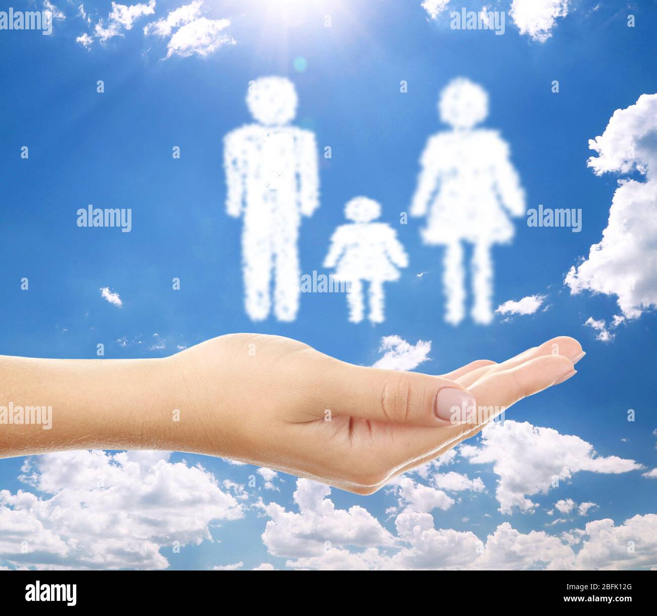 Family clouds shape floating on hand Stock Photo - Alamy