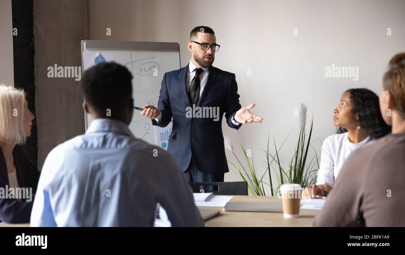 Serious male CEO make presentation to diverse employees Stock Photo - Alamy