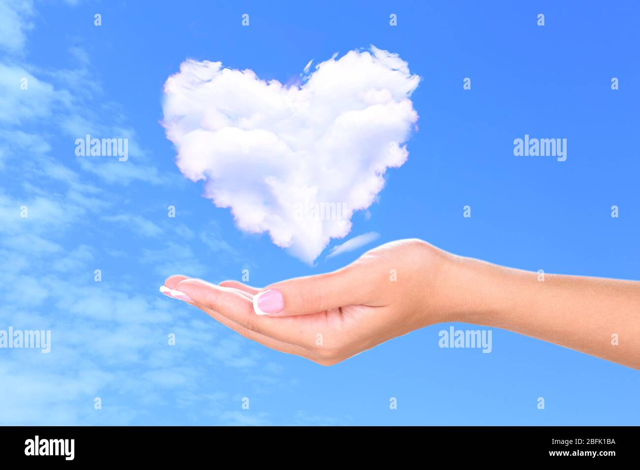 Heart clouds shape floating on hand Stock Photo - Alamy