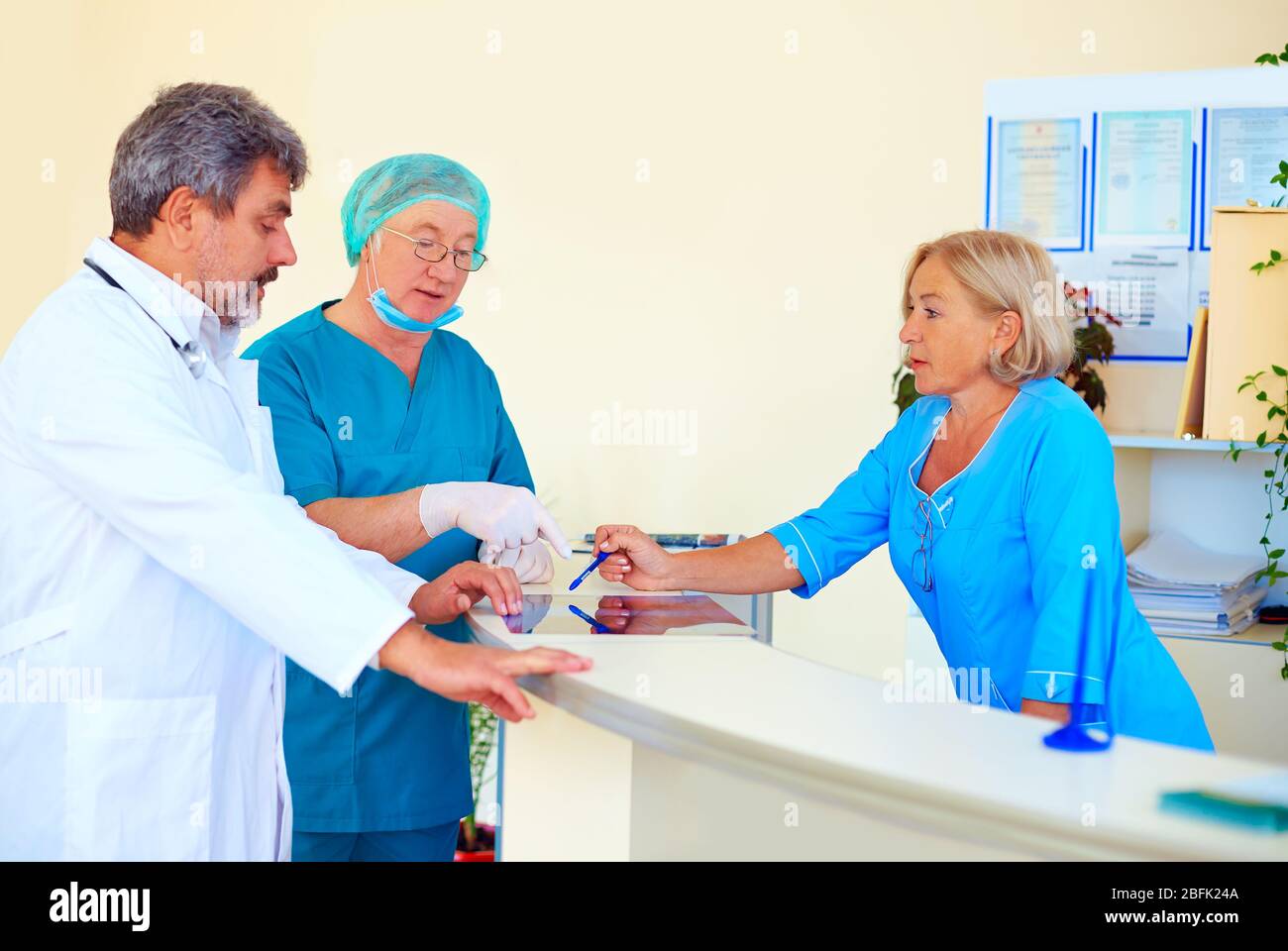 medical staff consulting about health record at hospital desk Stock ...