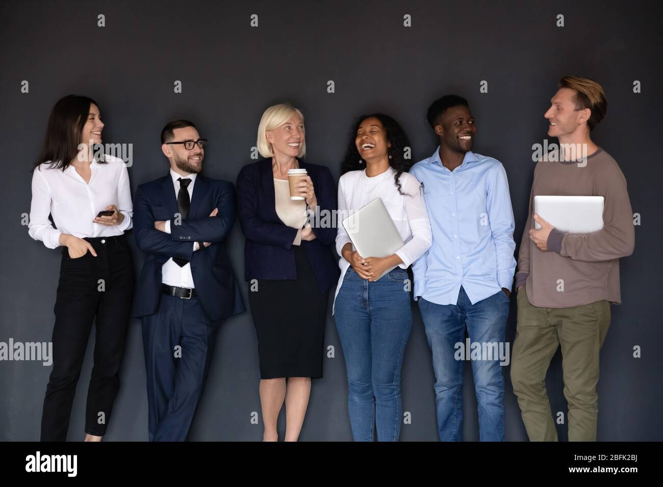 Happy diverse employees have fun talking at work break Stock Photo - Alamy