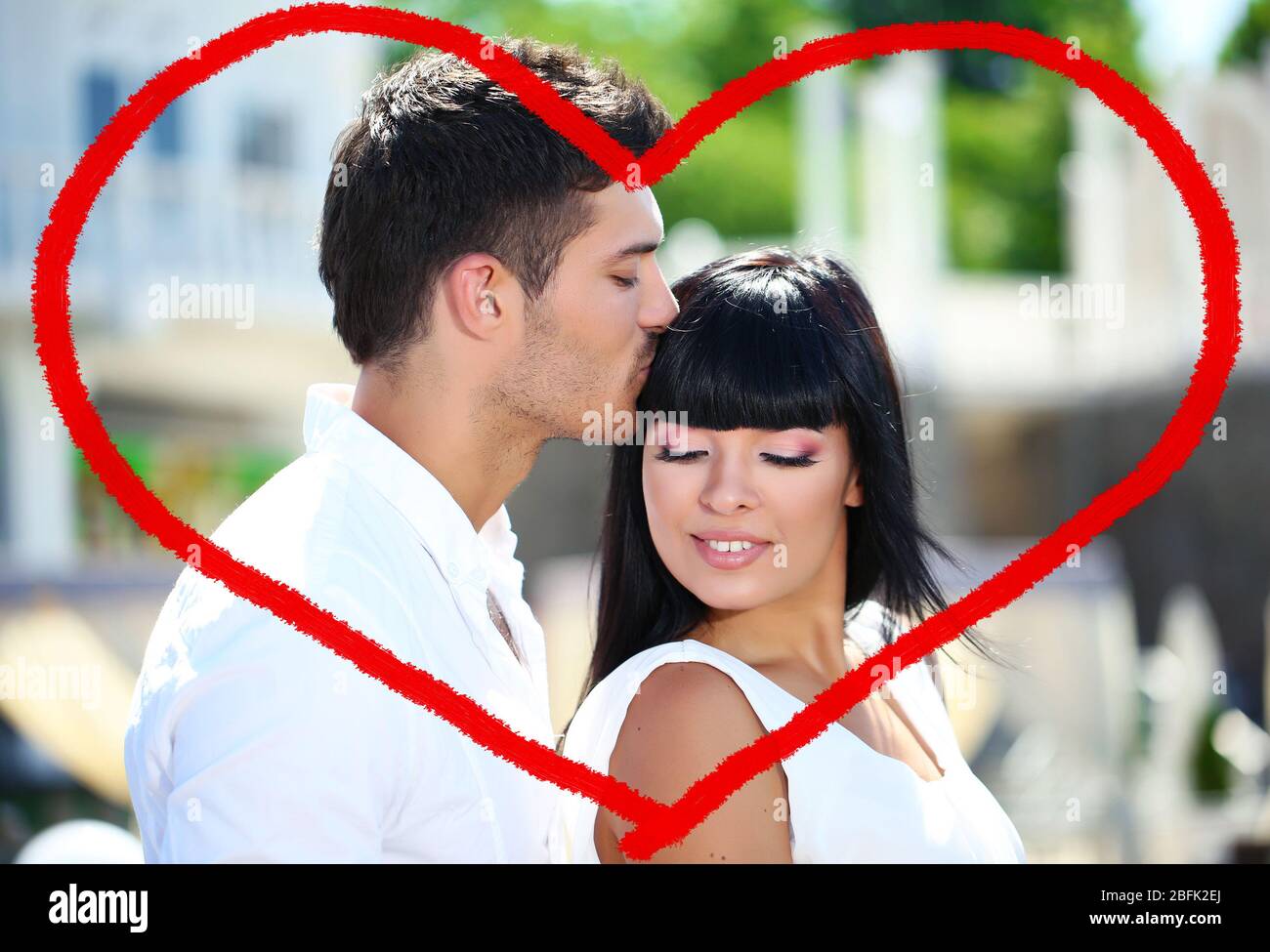 Beautiful young romantic couple and heart-shaped frame Stock Photo - Alamy