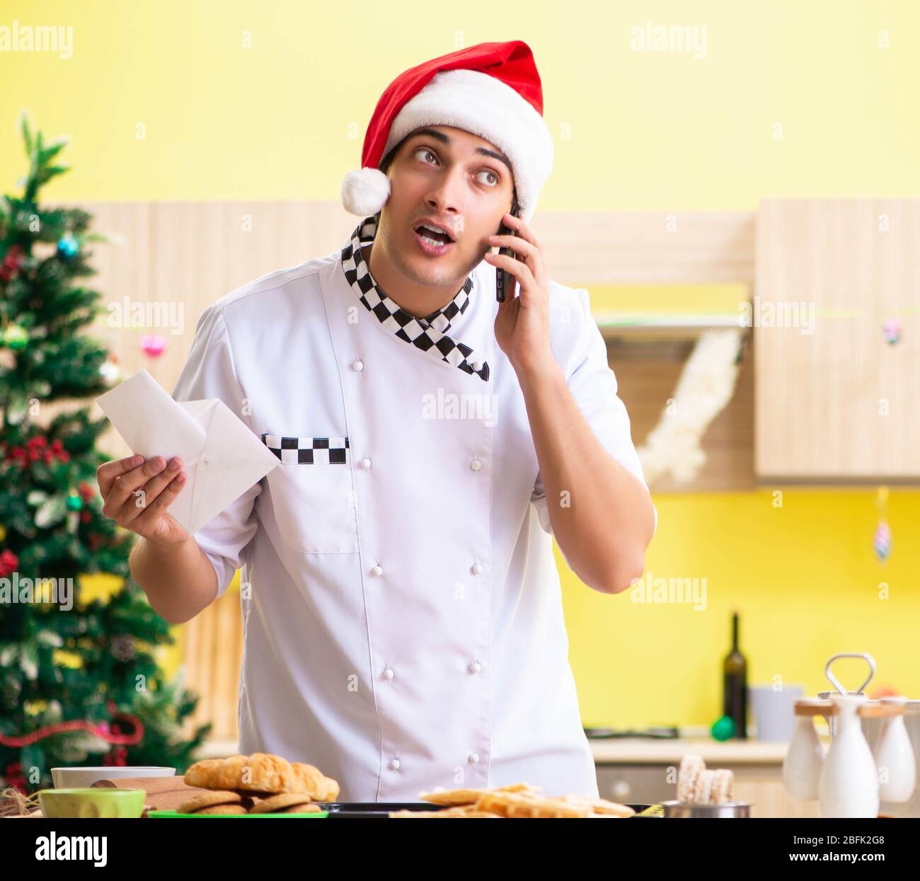 The young chef husband working in kitchen at christmas eve Stock Photo ...