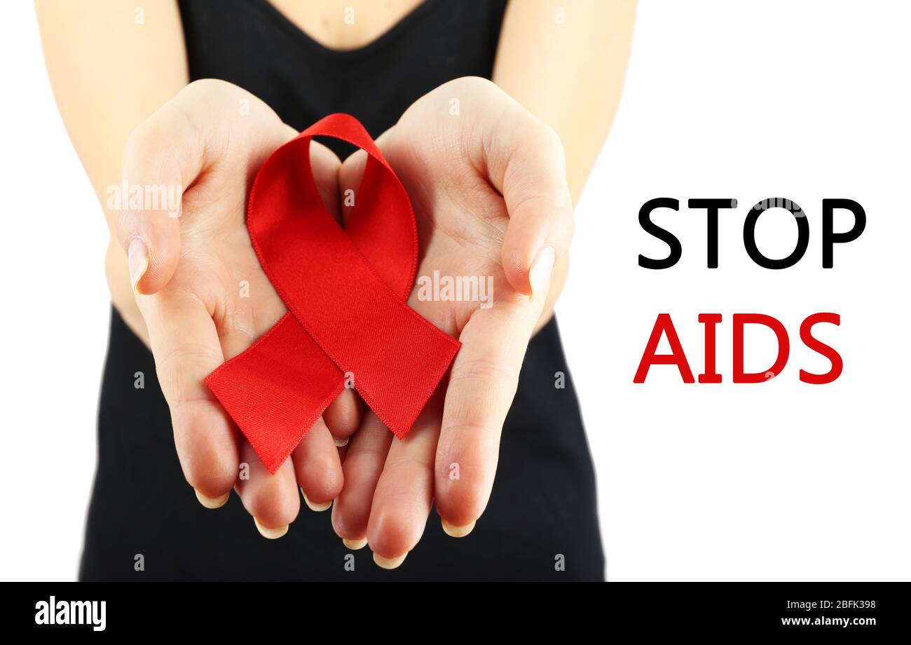 Woman in black holding red AIDS ribbon isolated on white Stock Photo ...