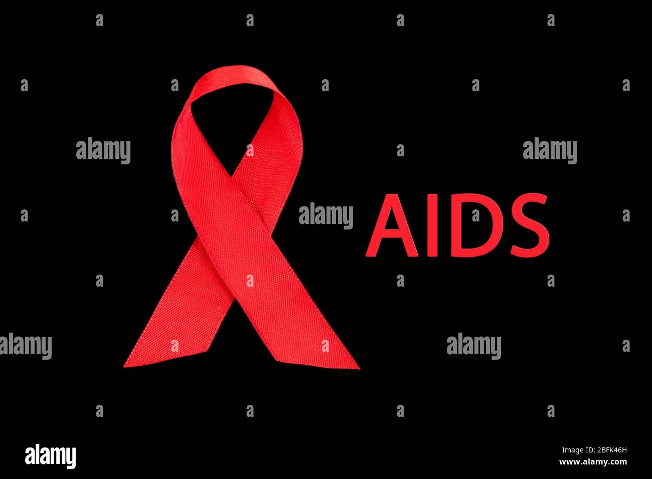 Red ribbon HIV, AIDS on black background Stock Photo - Alamy