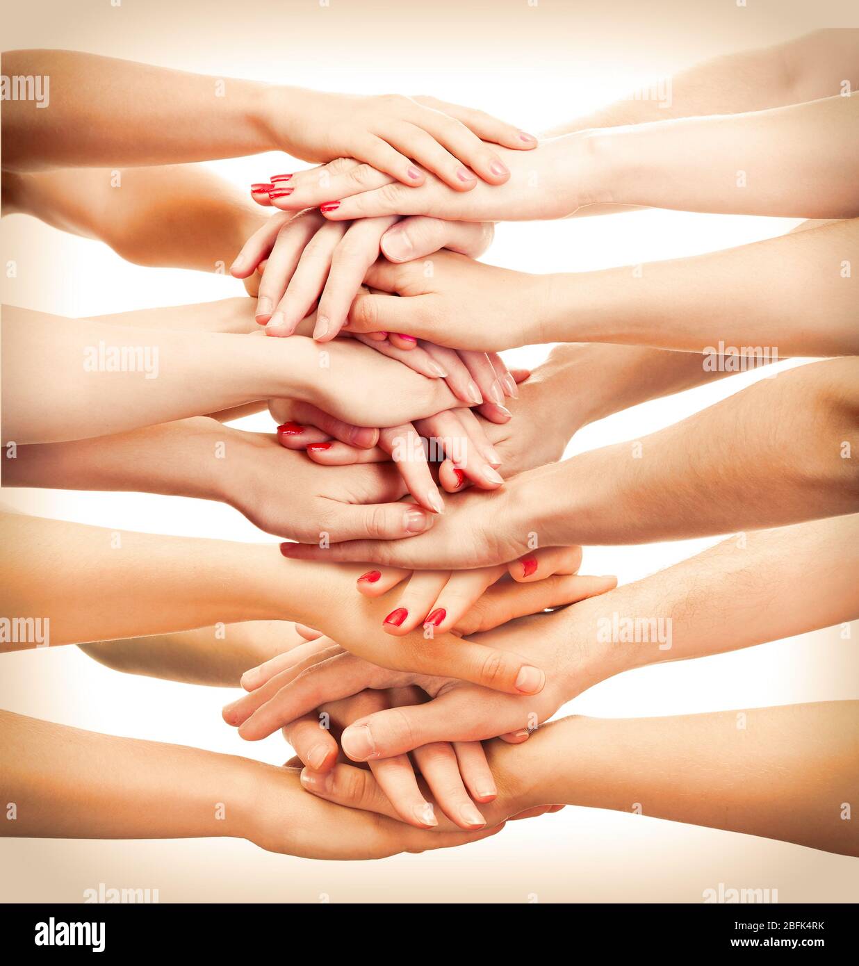 People's hands together on light background Stock Photo - Alamy