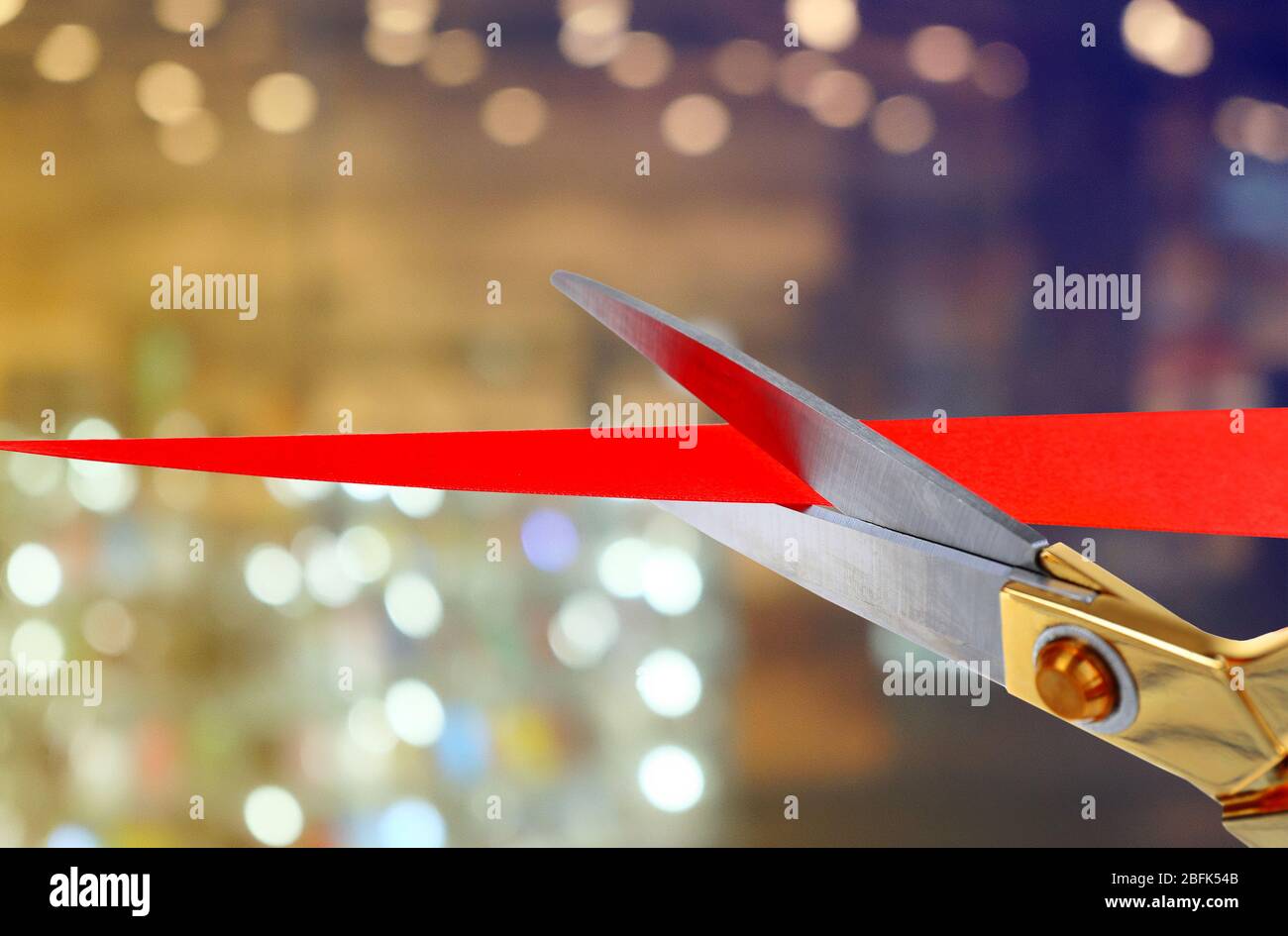 Scissors cutting red band hi-res stock photography and images - Alamy