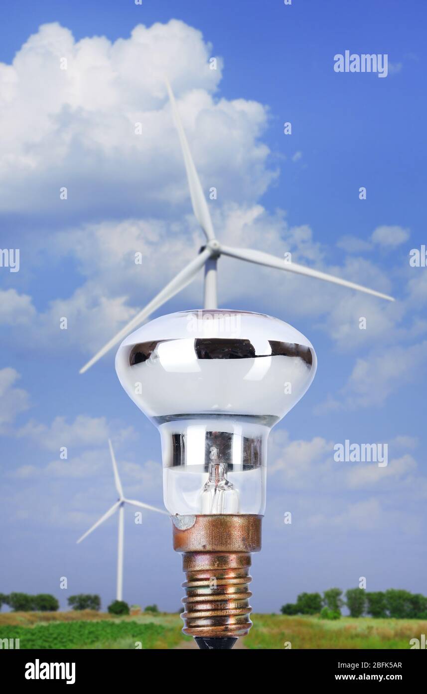 Light bulb on windmills field background Stock Photo - Alamy