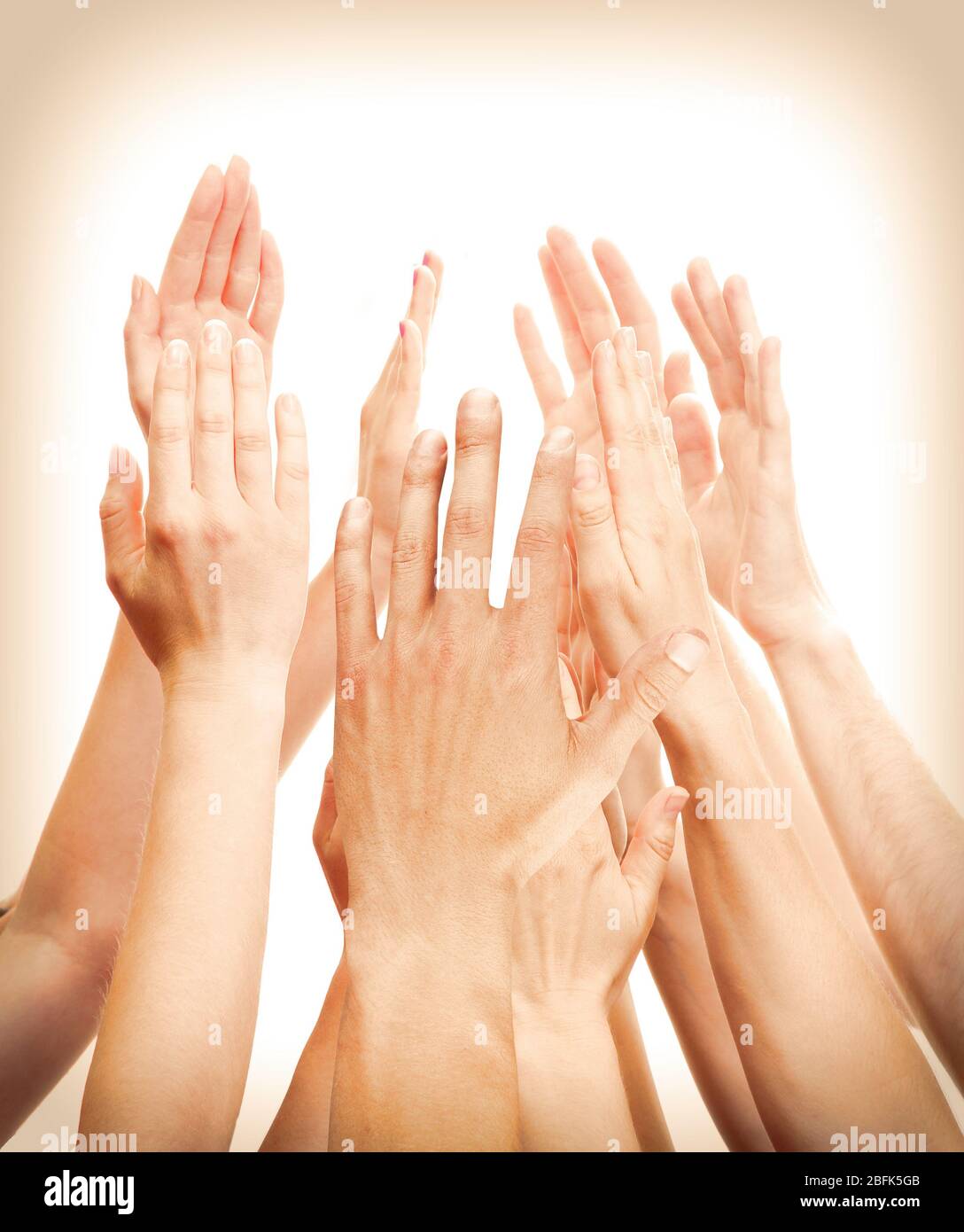 People's hands together on light background Stock Photo - Alamy