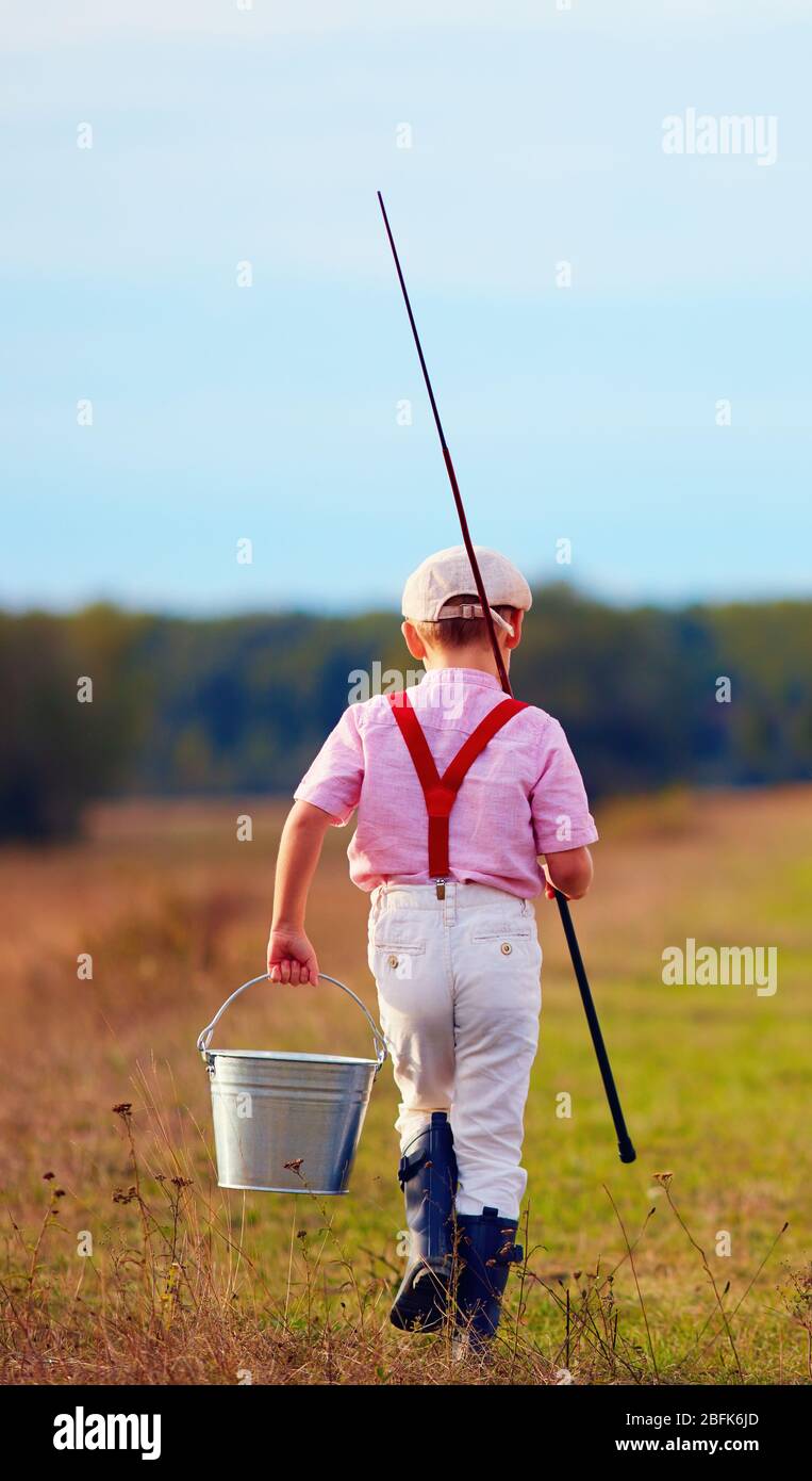 rear view of cute kid walking for fishing Stock Photo - Alamy