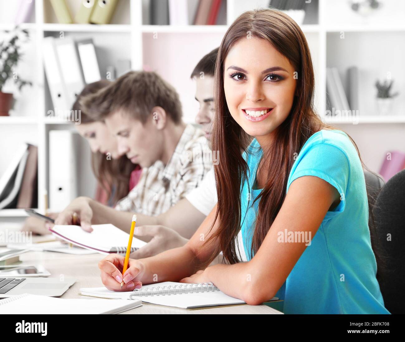 Young students sitting in classroom Stock Photo - Alamy