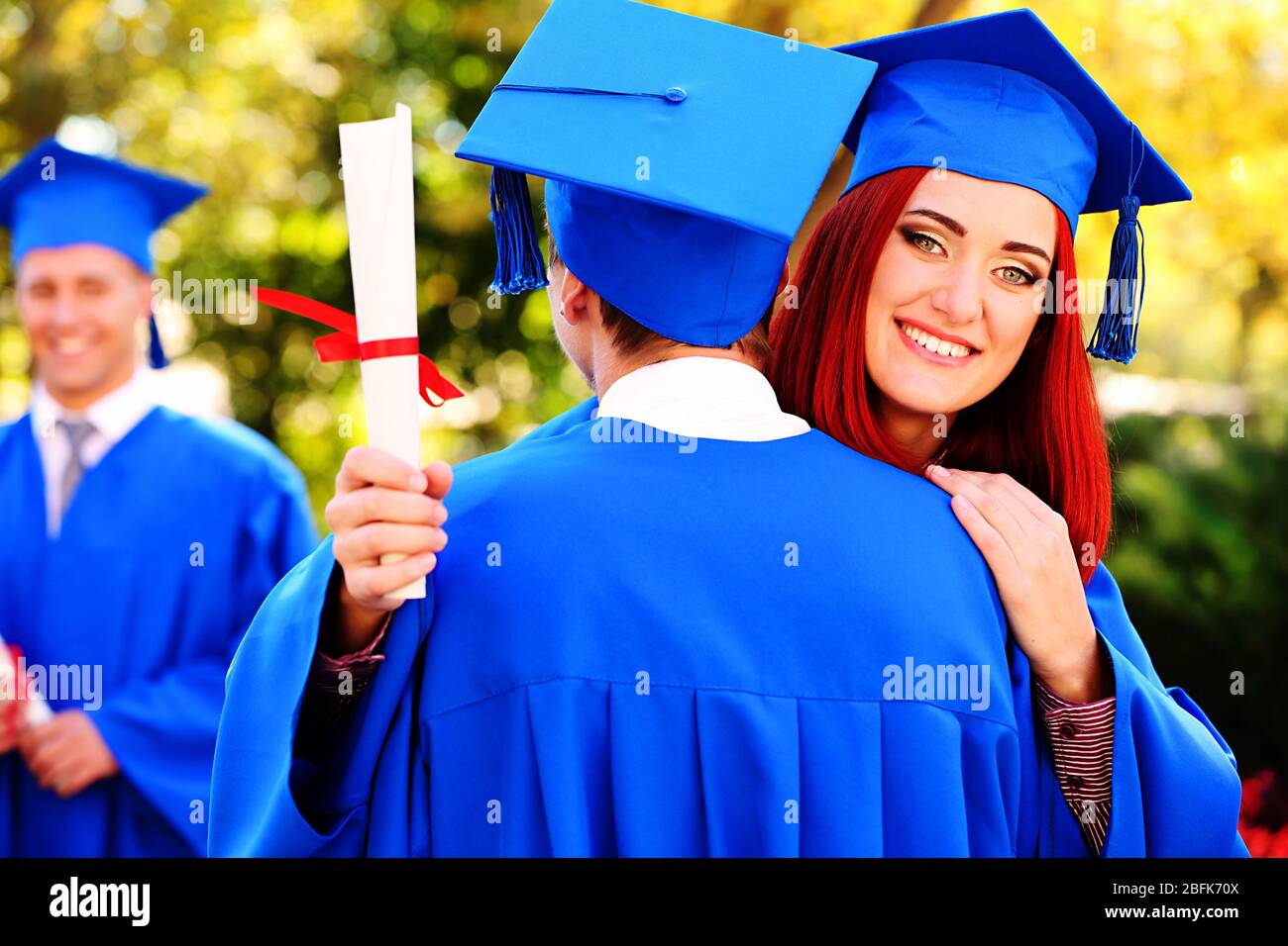 Graduated students in graduation hats and gowns, outdoors Stock Photo ...