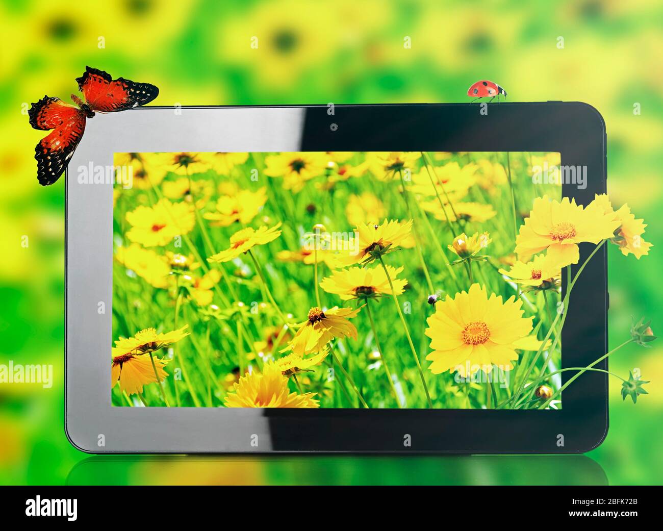 Tablet with nature wallpaper on screens on natural background Stock ...