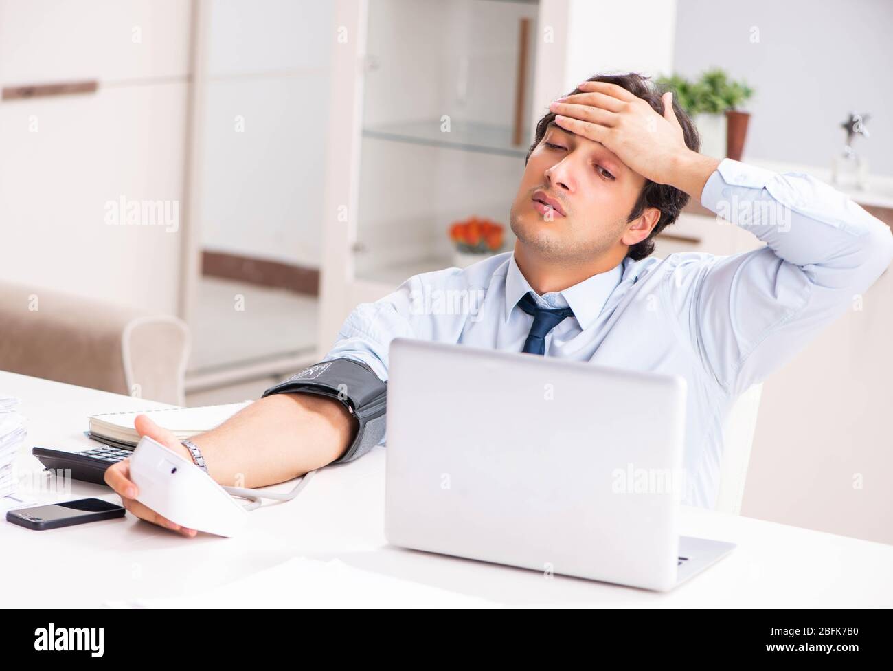 The man under stress measuring his blood pressure Stock Photo - Alamy
