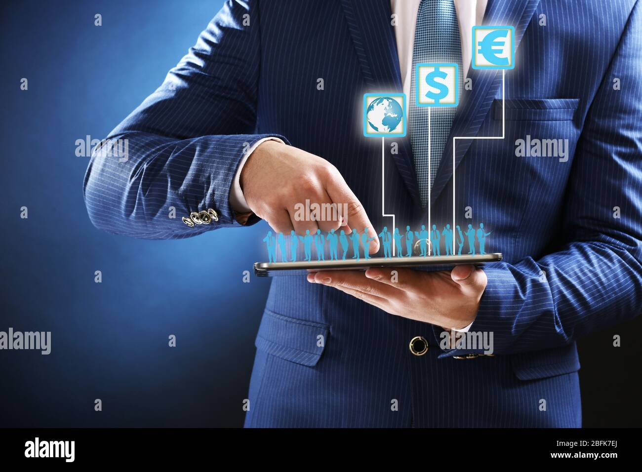 Businessman holding a tablet with a projected on-screen bar graph ...