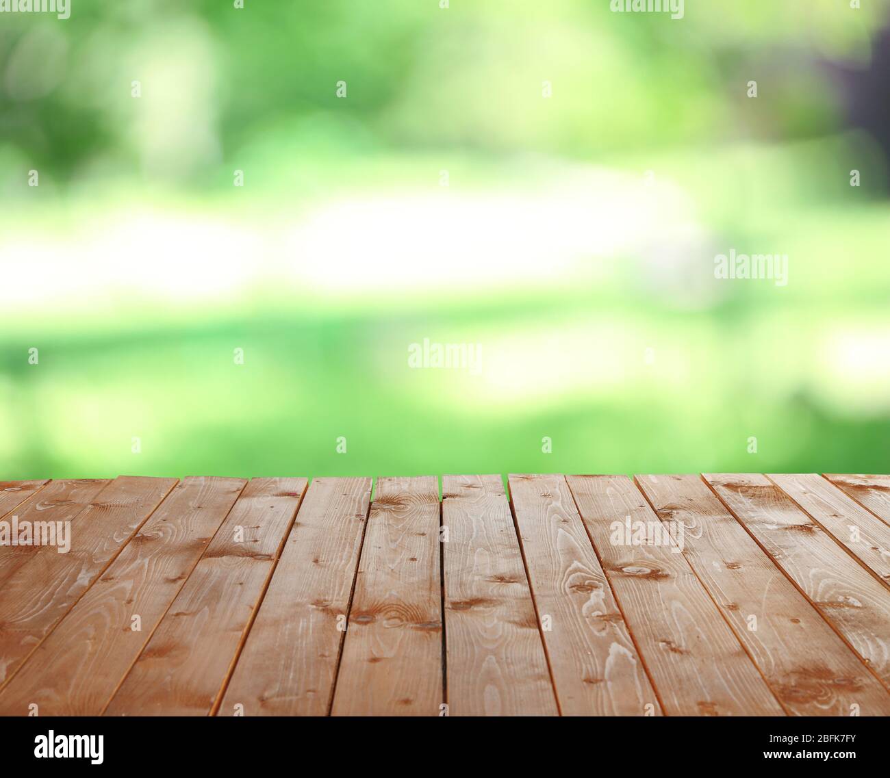 Wooden table with abstract blur background Stock Photo - Alamy