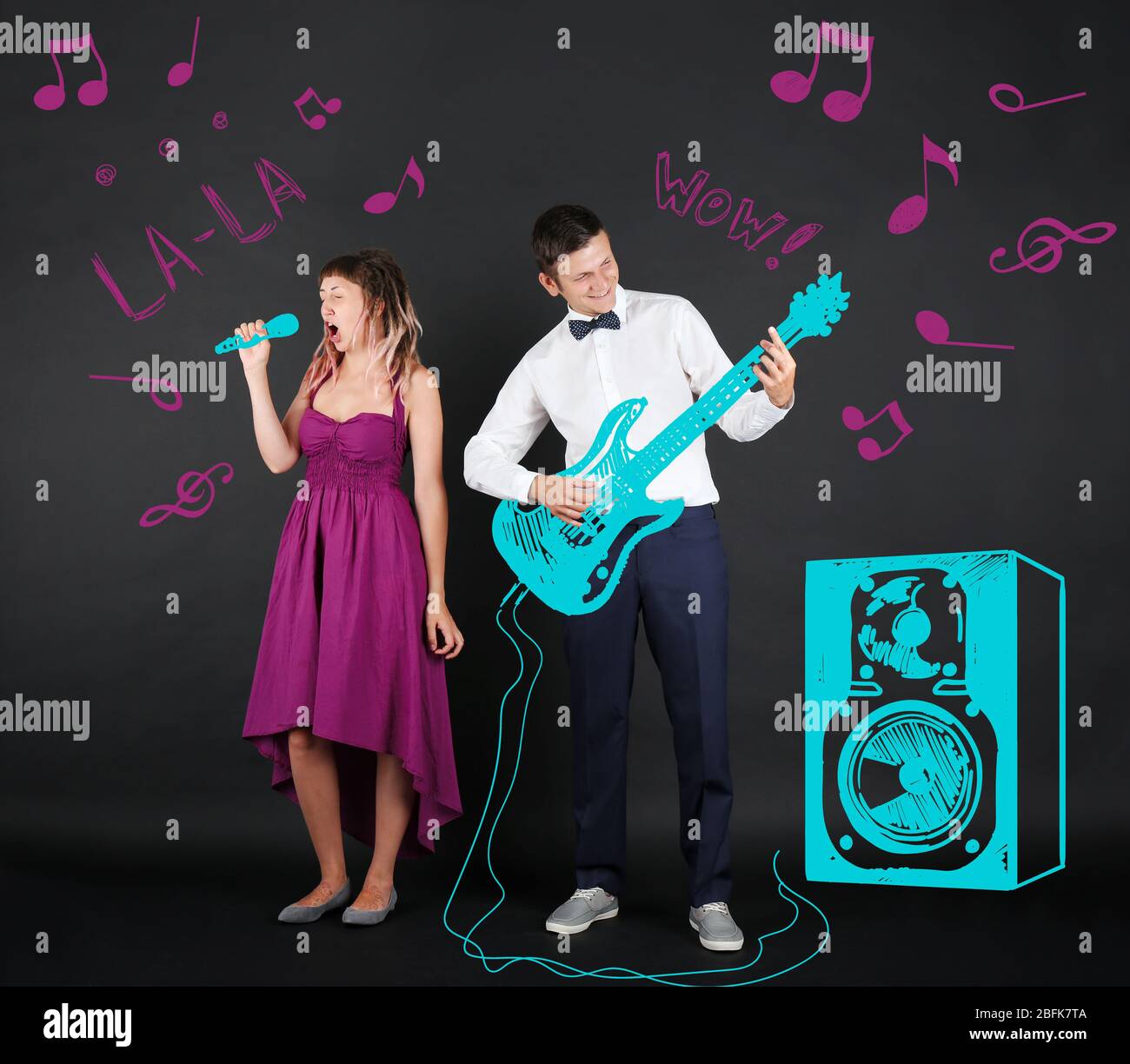 Musical young couple, on black background Stock Photo - Alamy