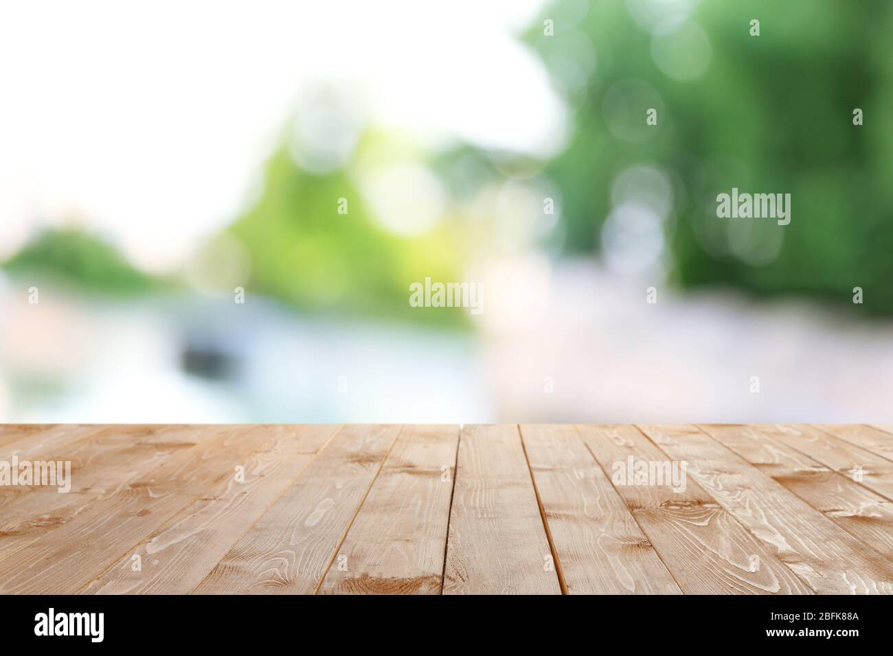 Wooden table with abstract blur background Stock Photo - Alamy