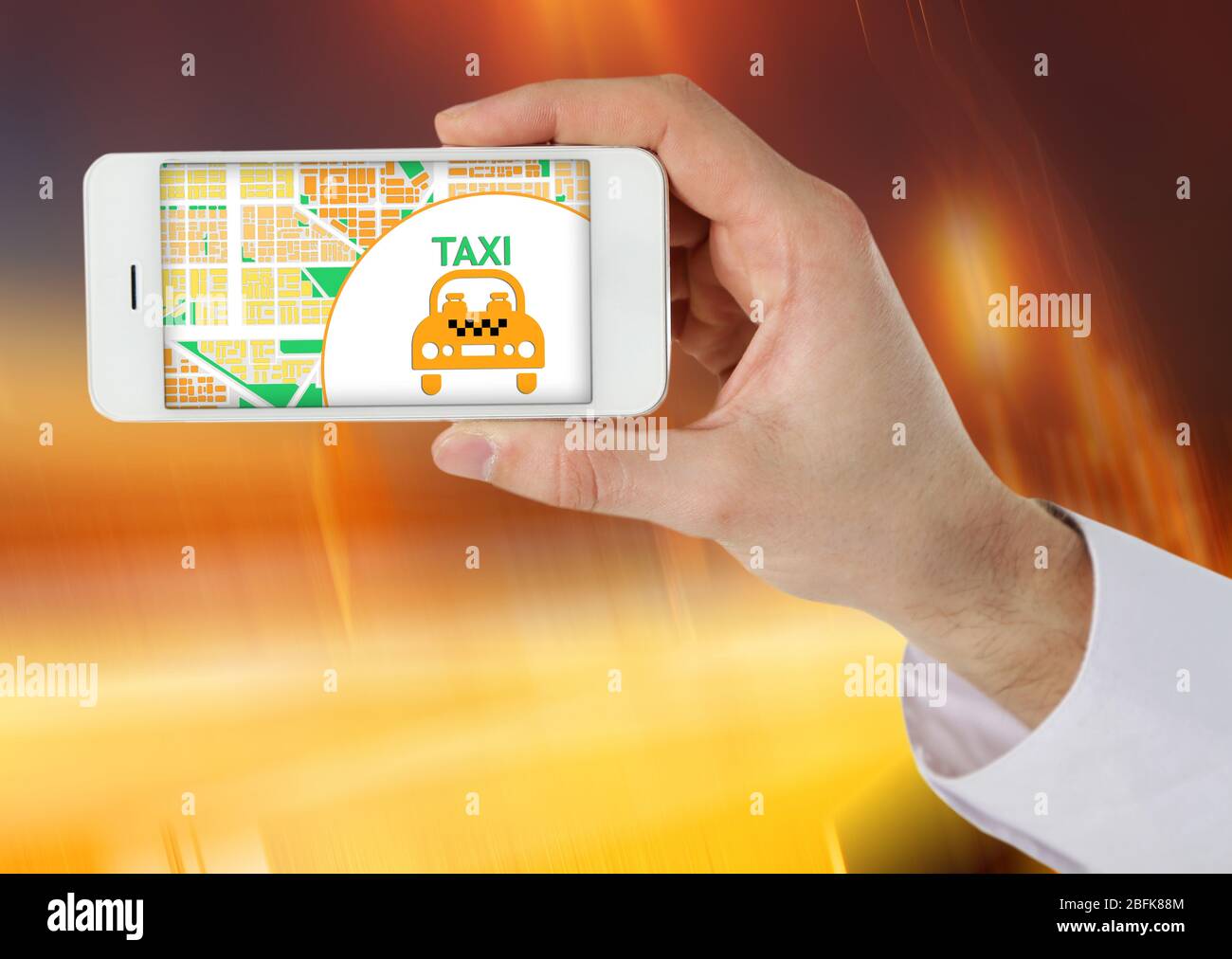 Hand holding mobile smart phone with interface taxi on night background ...