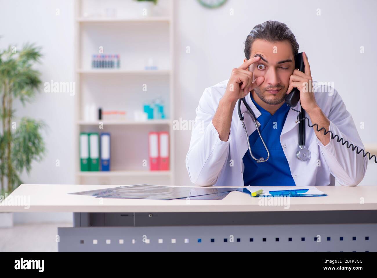 Young doctor being tired after night shift Stock Photo - Alamy