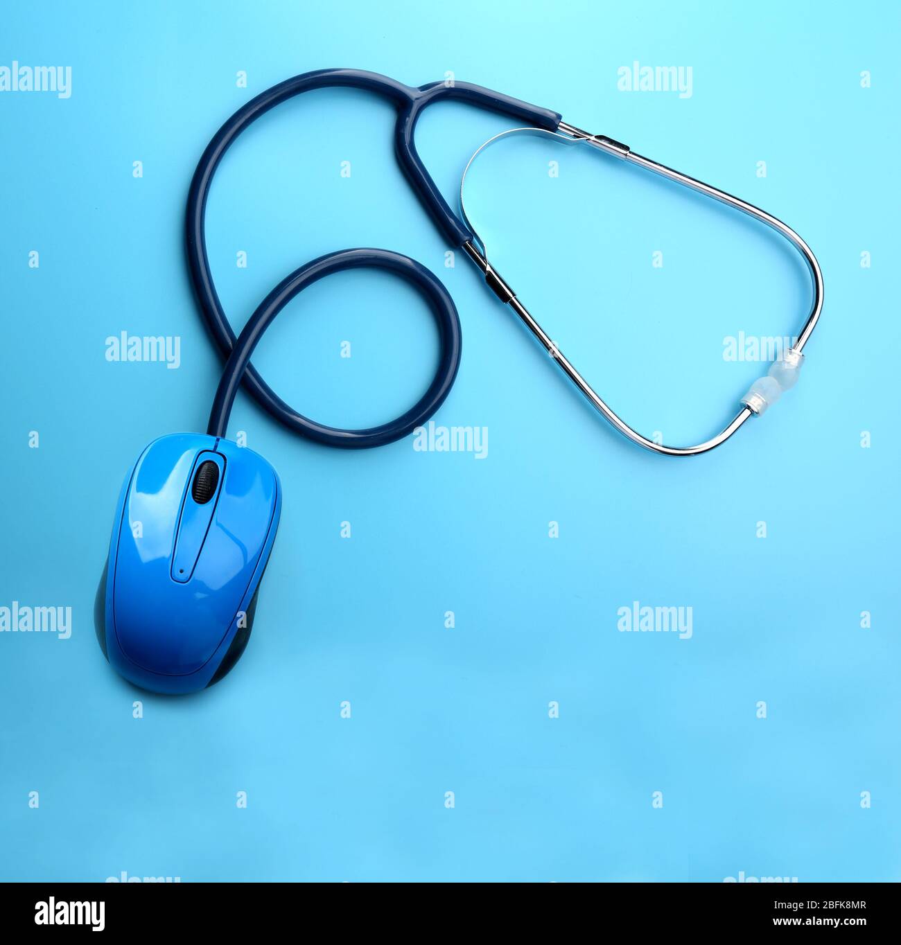 Stethoscope with computer mouse on blue background. Medical online ...