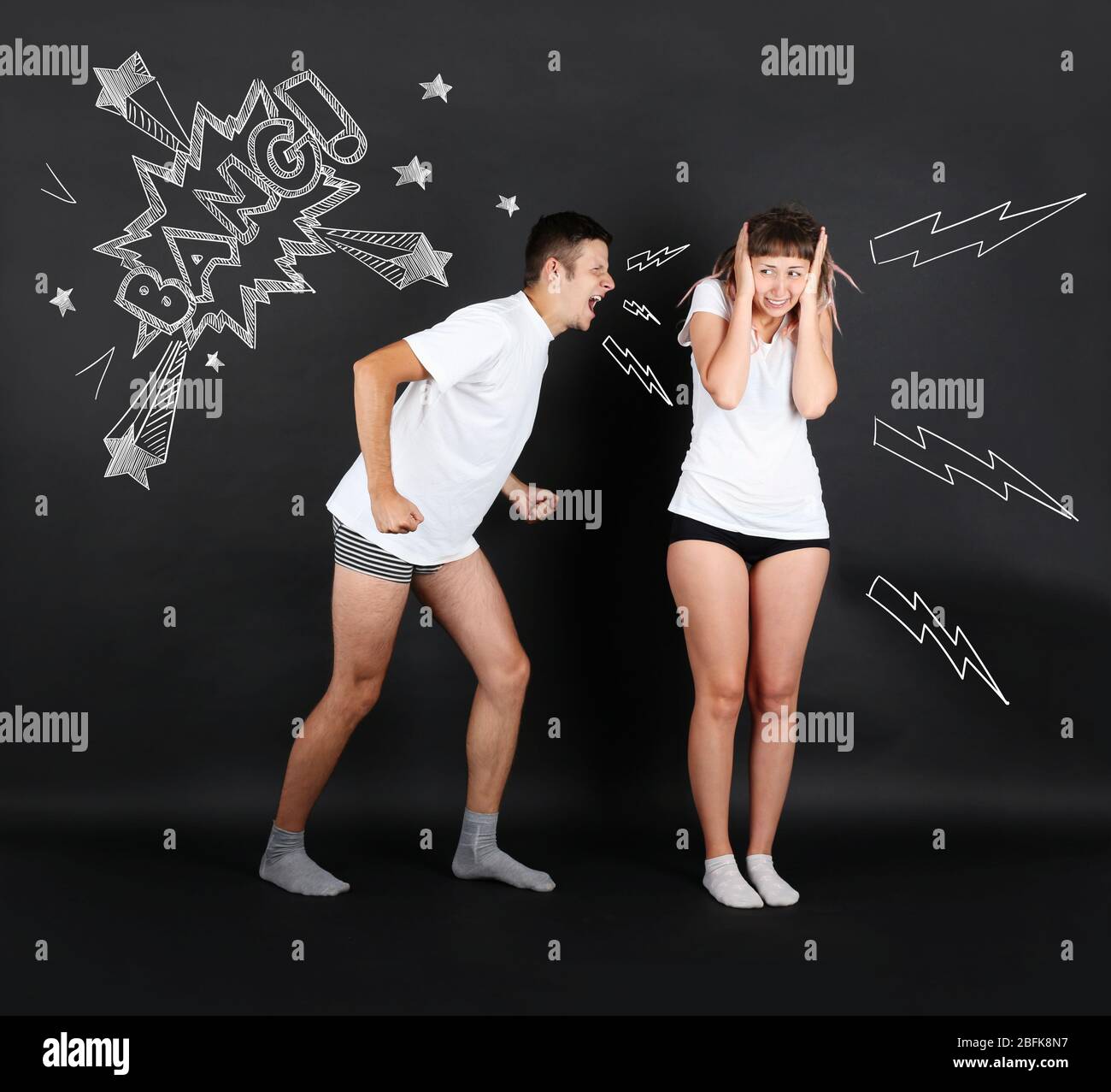 Young couple screaming on each other , on black background Stock Photo ...