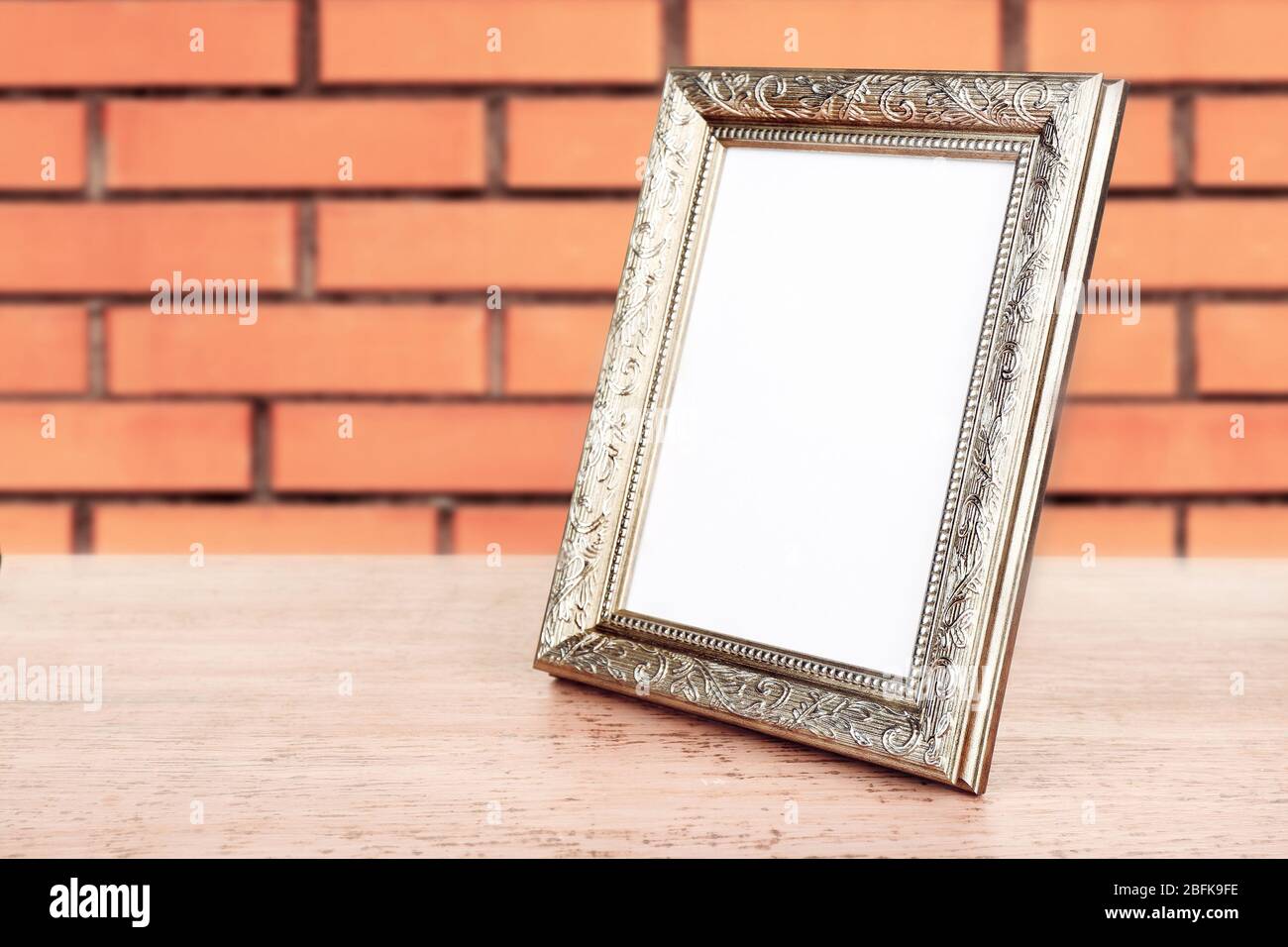 Old empty frame on brick wall background Stock Photo - Alamy