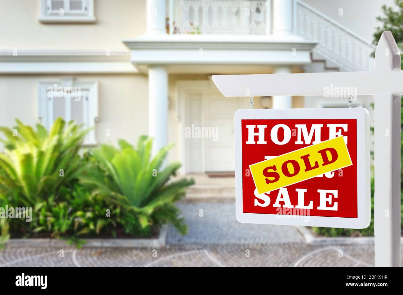 Real estate sign in front of new house for sale Stock Photo - Alamy