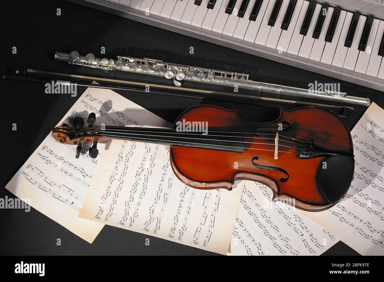 Musical instruments with music notes on dark background Stock Photo - Alamy