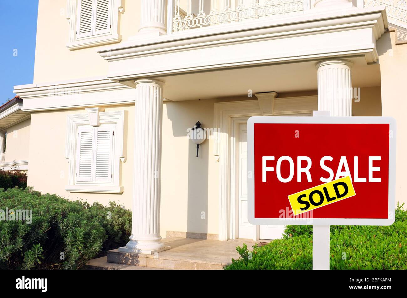 Real estate sign in front of new house for sale Stock Photo - Alamy