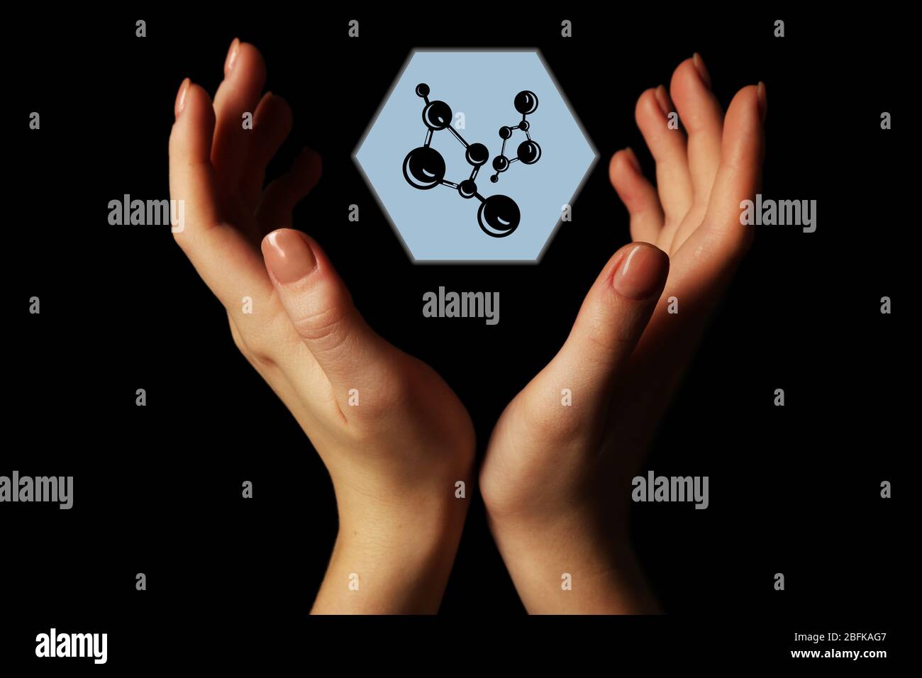 Hands with atom image, on black background Stock Photo - Alamy