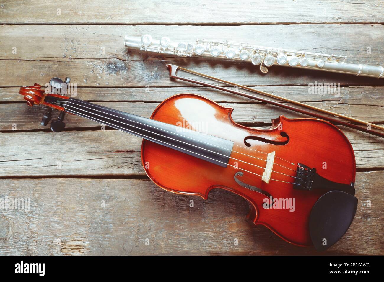 Flute with violin on table close up Stock Photo - Alamy