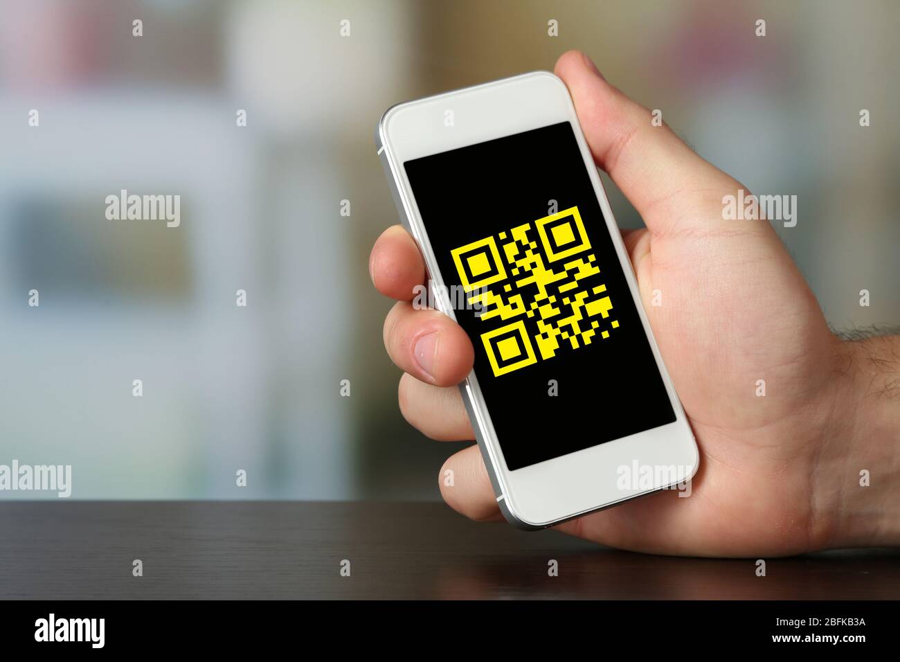 Hand holding smart phone with QR code on screen Stock Photo - Alamy