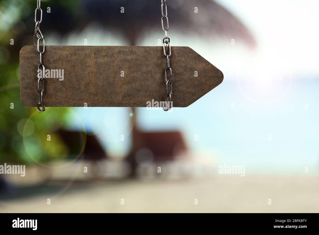 Wooden sign arrow on nature background Stock Photo - Alamy