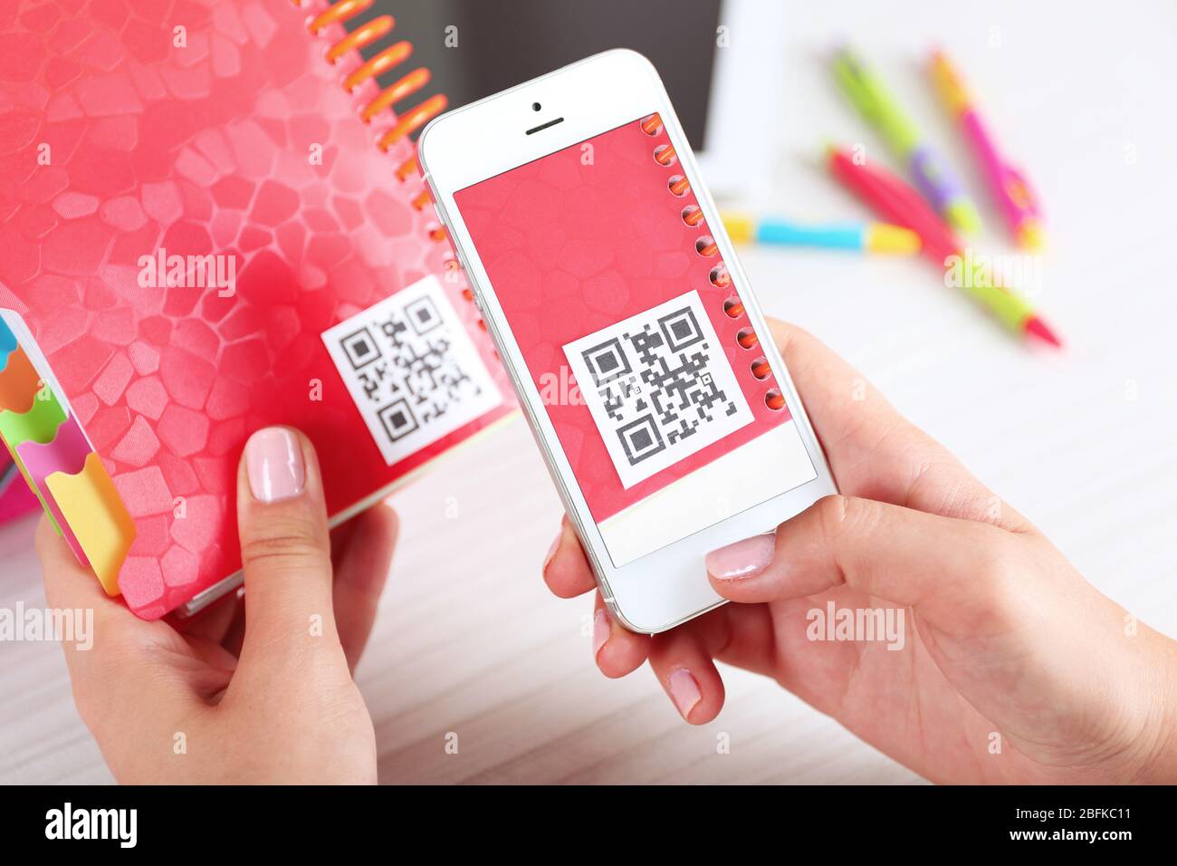Woman scanning voucher code with mobile phone close up Stock Photo - Alamy