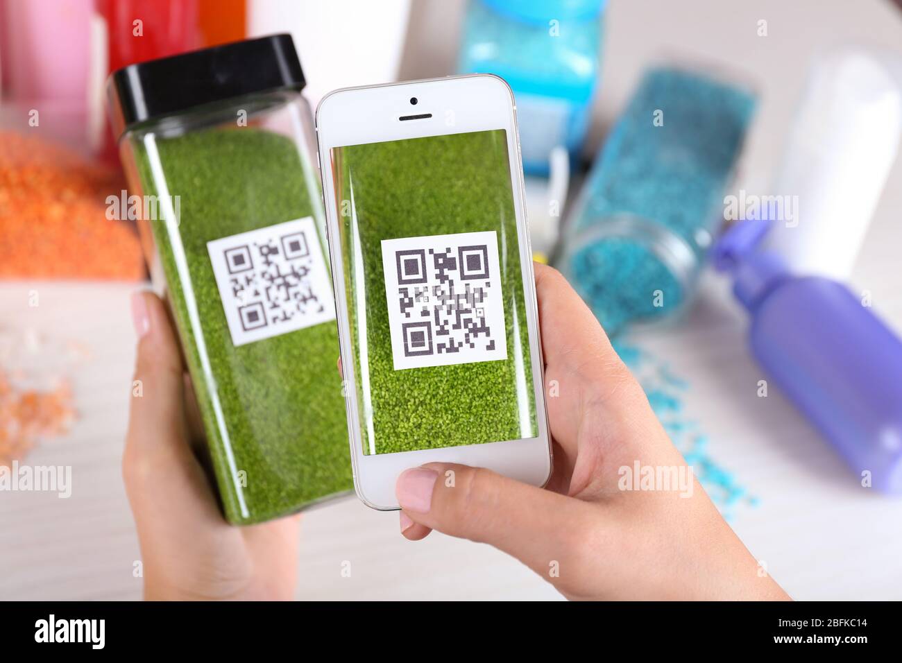 Woman scanning voucher code with mobile phone close up Stock Photo - Alamy