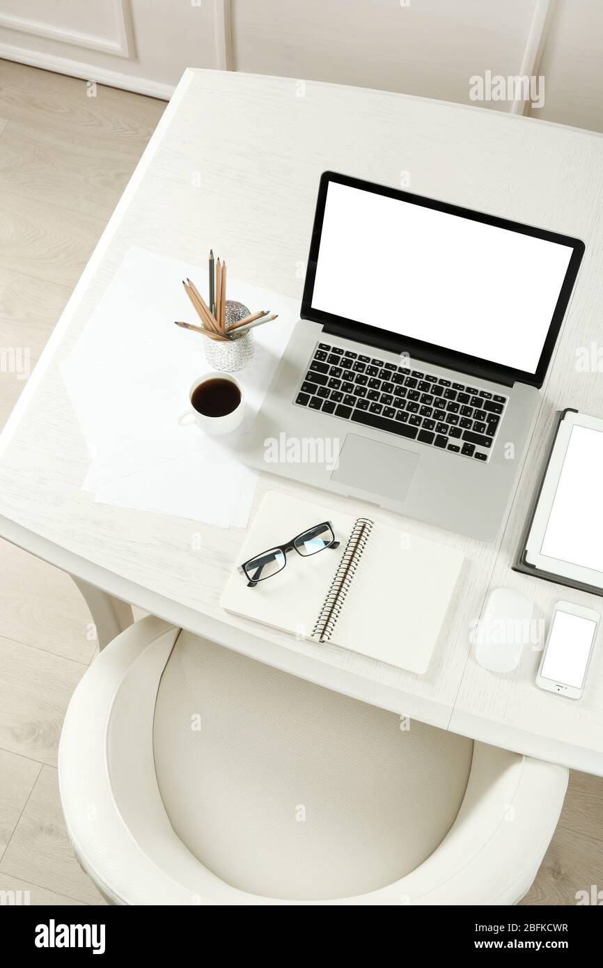 Workplace with laptop in room Stock Photo - Alamy