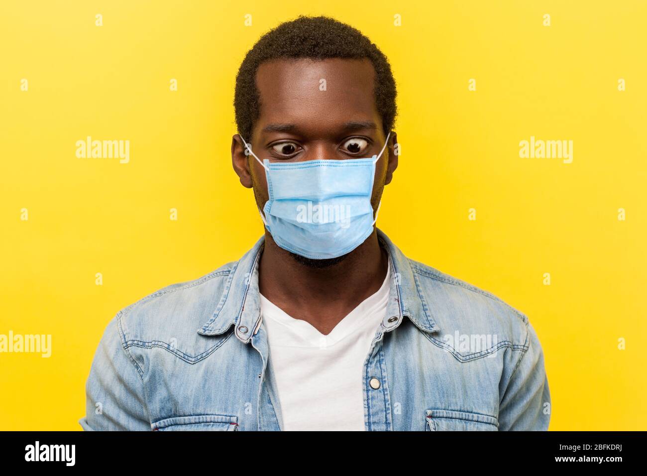 Portrait of silly crazy man with surgical medical mask crossing eyes ...