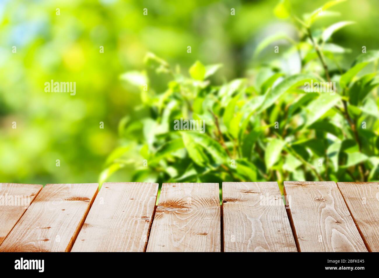 Wooden table with nature background Stock Photo - Alamy