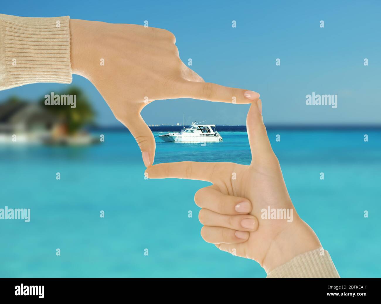 Woman holds hands in the shape of a frame on nature background Stock ...