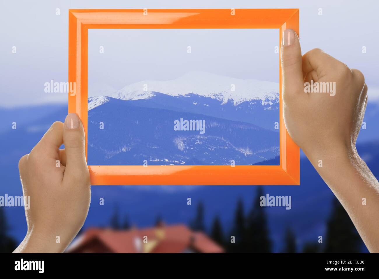 Woman hands holding empty frame on nature background Stock Photo - Alamy