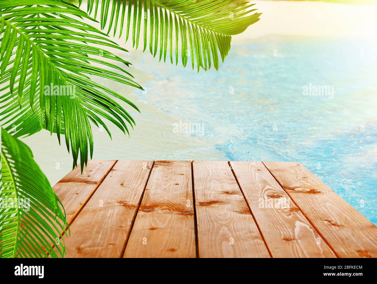 Wooden table with tropical paradise background Stock Photo - Alamy
