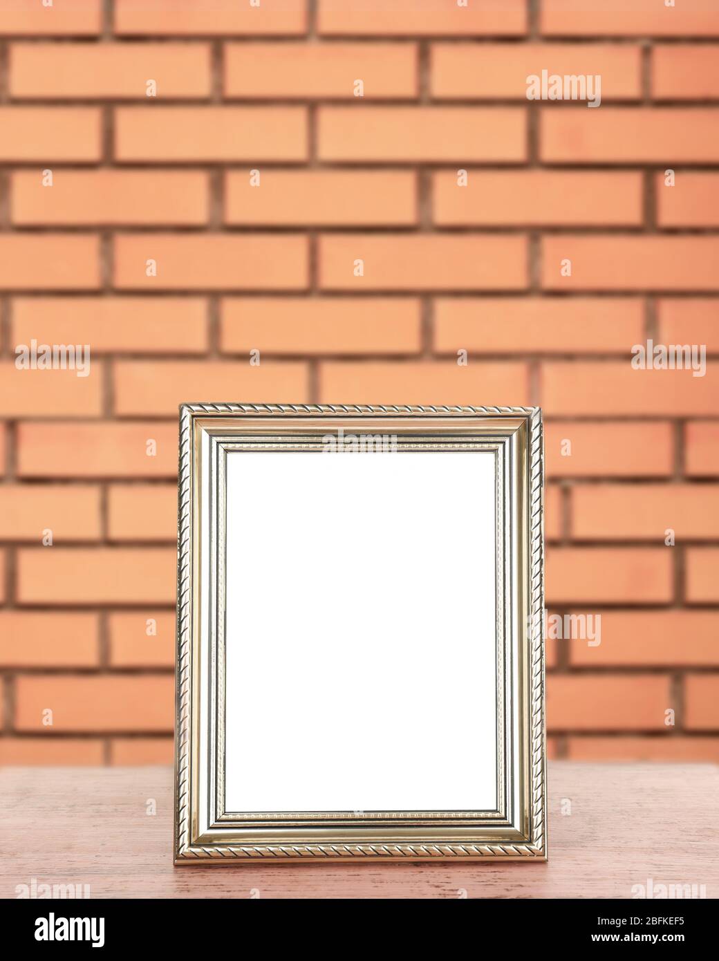 Old empty frame standing on table on brick wall background Stock Photo ...