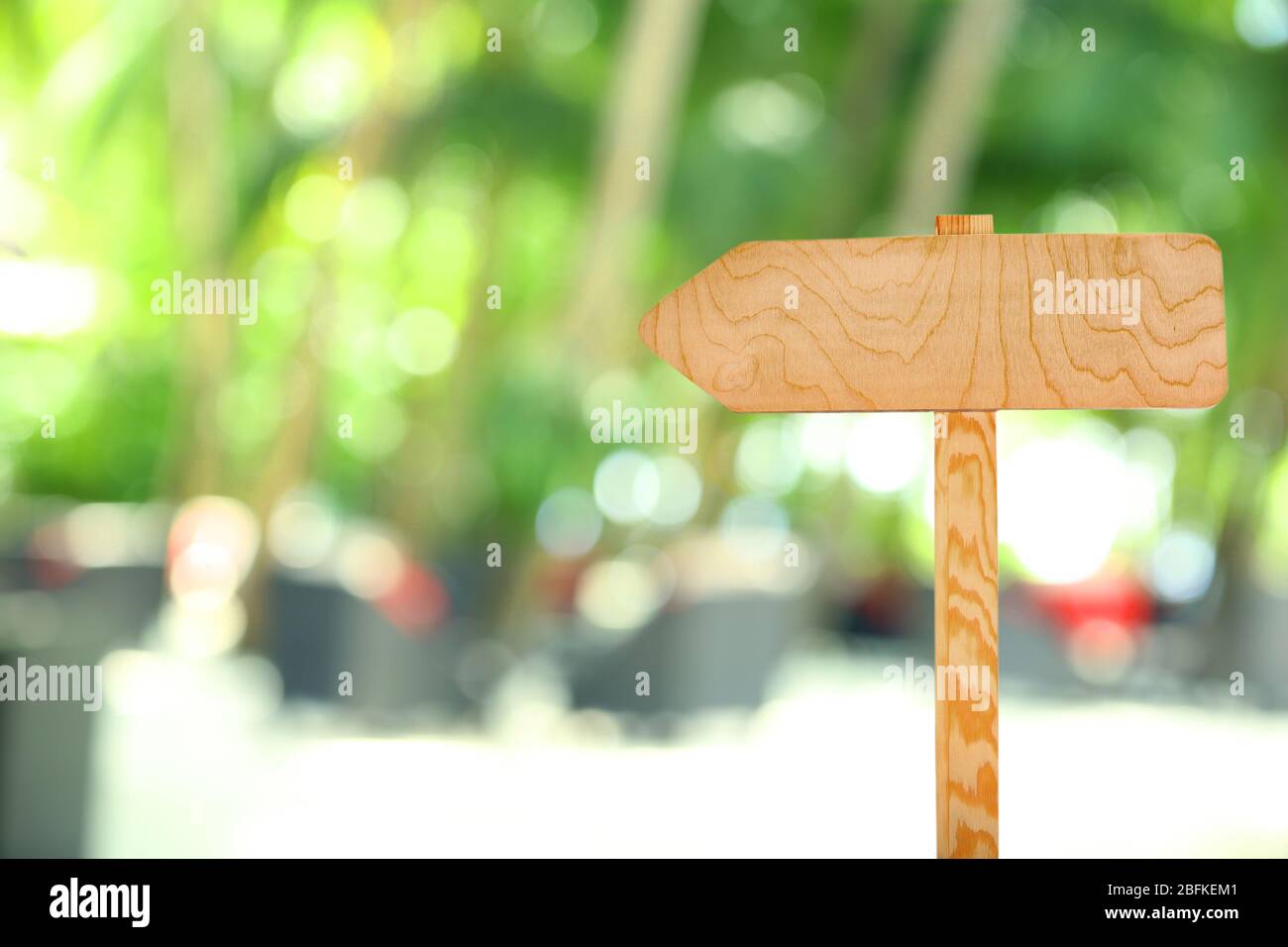 Wooden sign arrow on nature background Stock Photo - Alamy